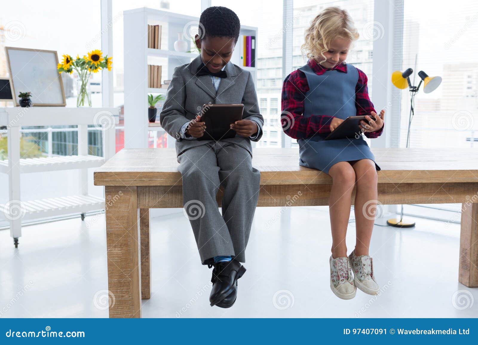 Business People Using Digital Tablets while Sitting on Table in ...