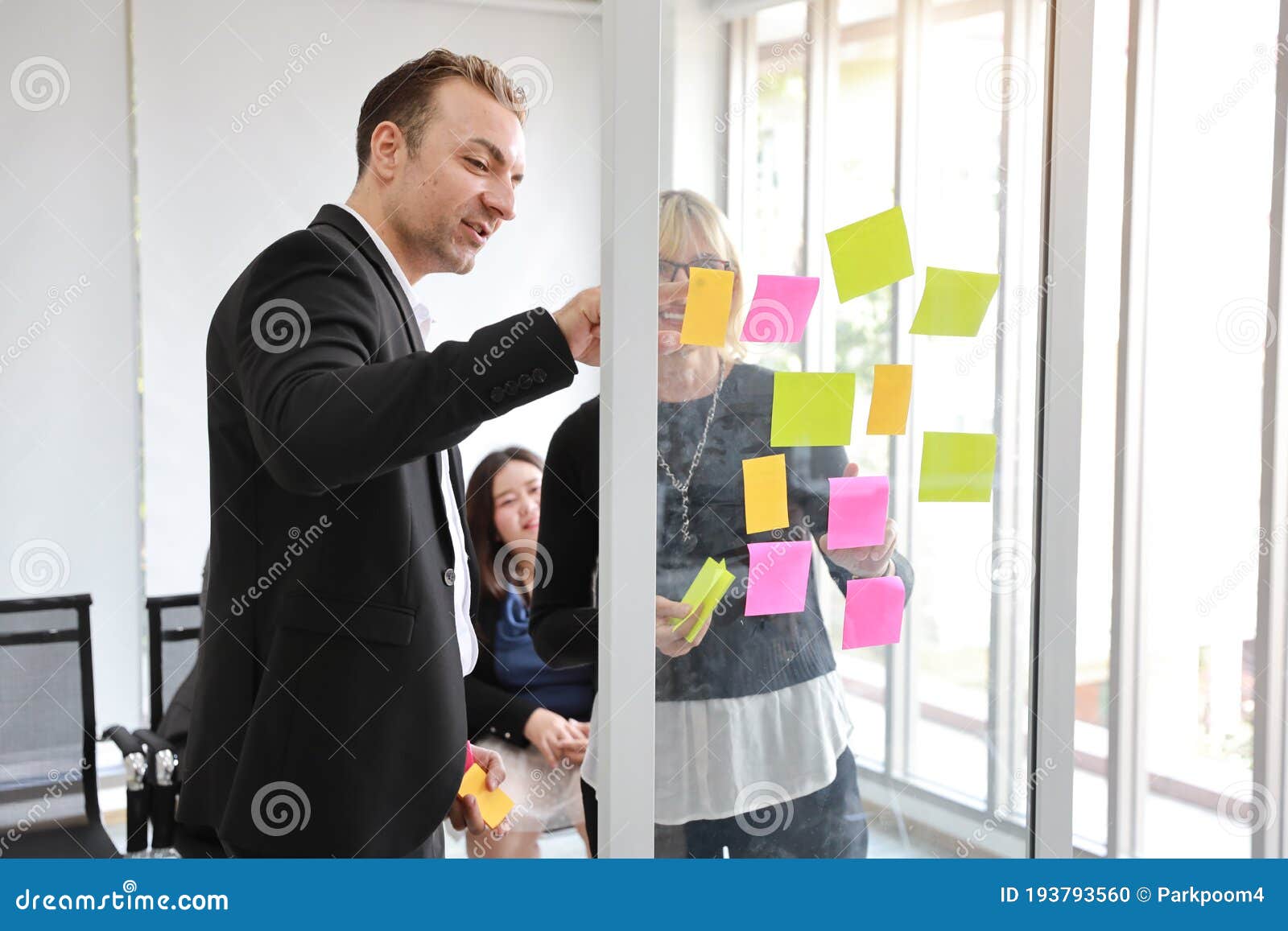 Business People Using Post it Notes for Brainstorming or Sharing Idea ...