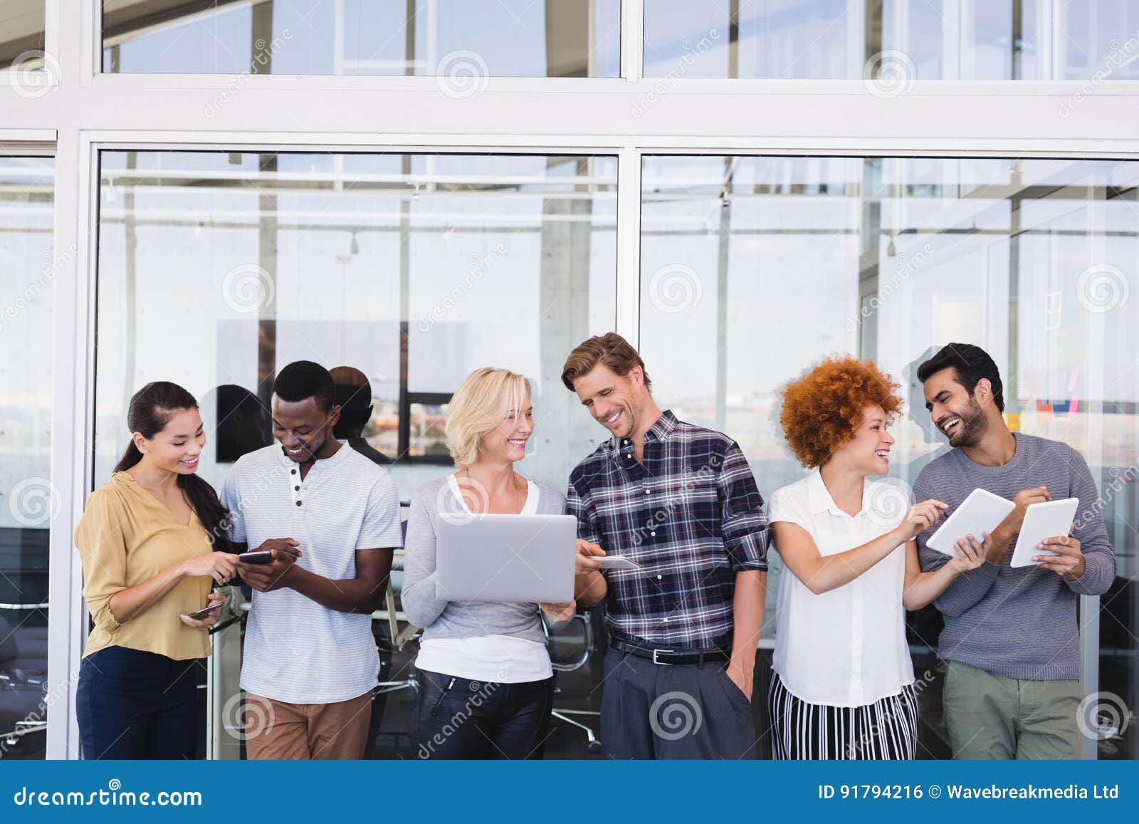 Business People Using Technologies while Discussing in Balcony Stock ...