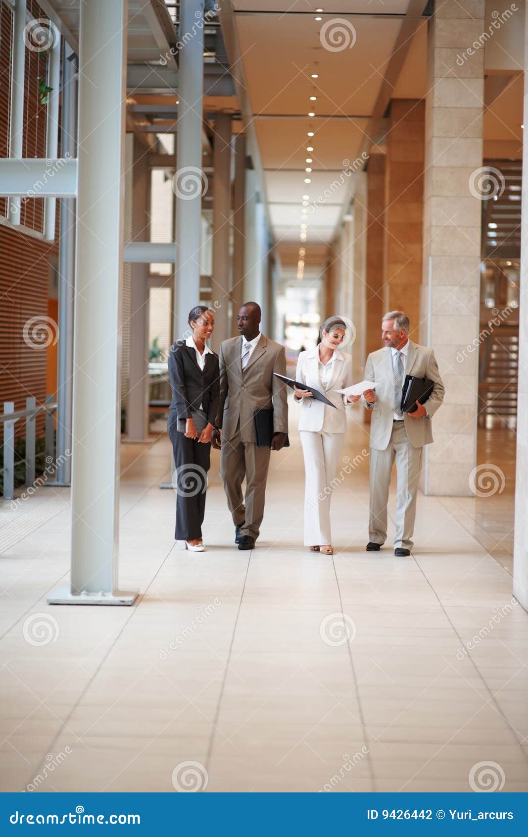 Business People Walking through the Hallway Stock Photo - Image of ...
