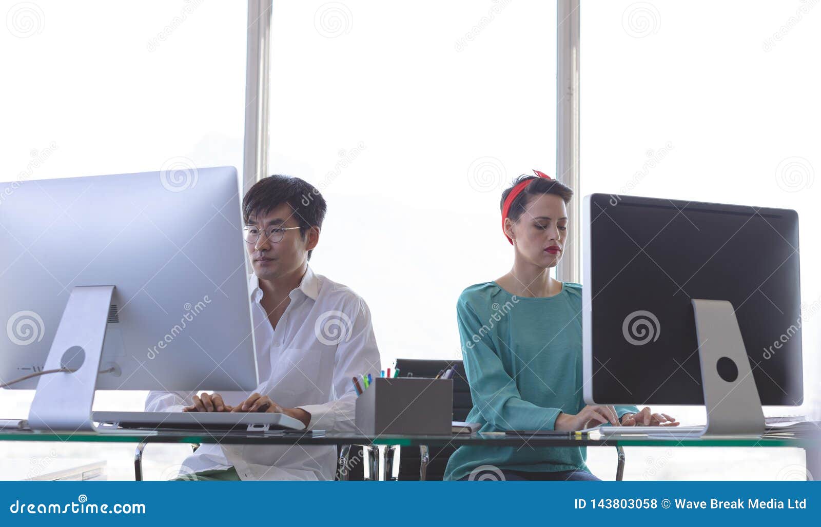 Business People Working on Computer at Desk in Office Stock Photo ...