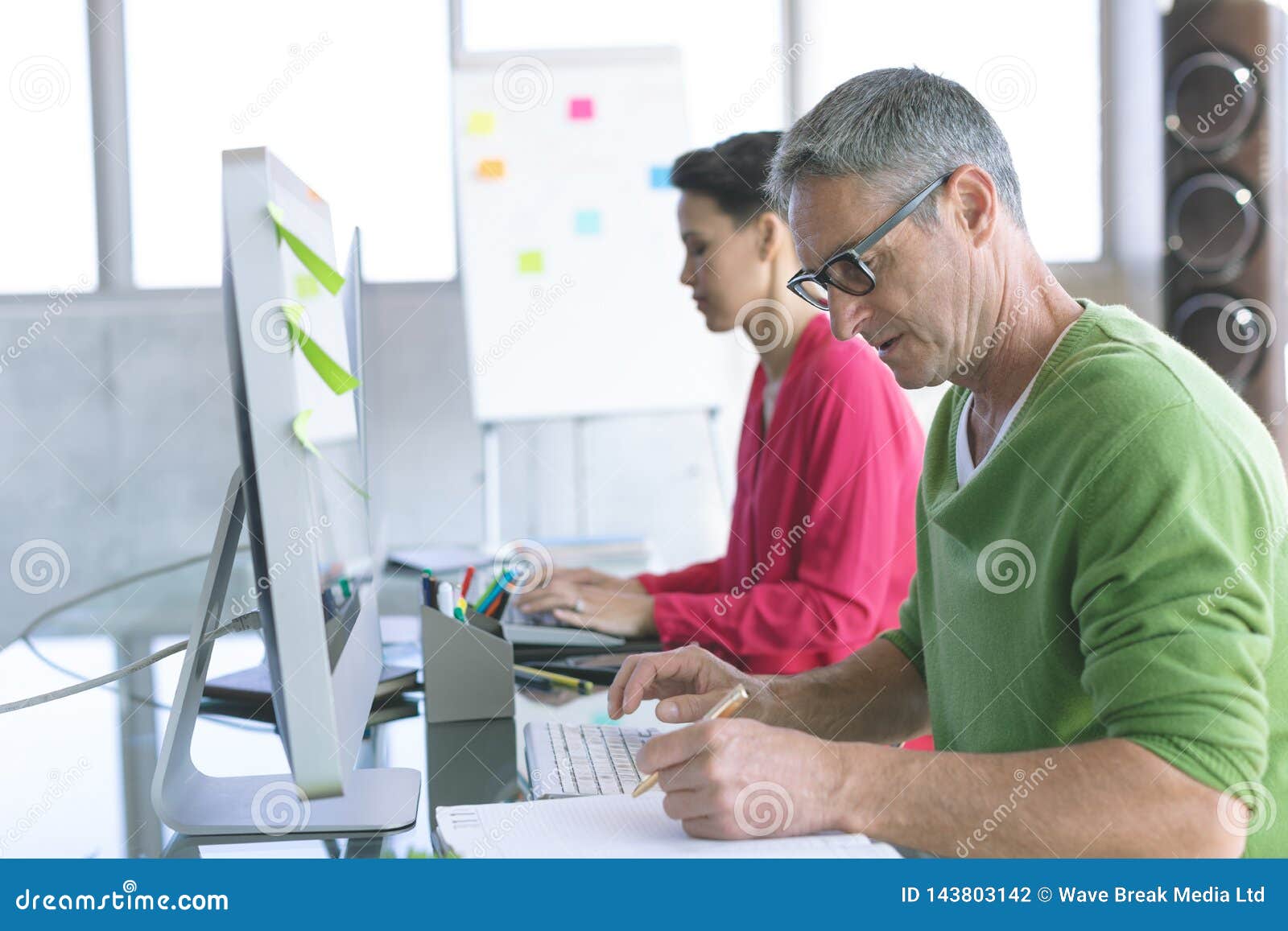 Business People Working on Computer at Desk in Office Stock Photo ...
