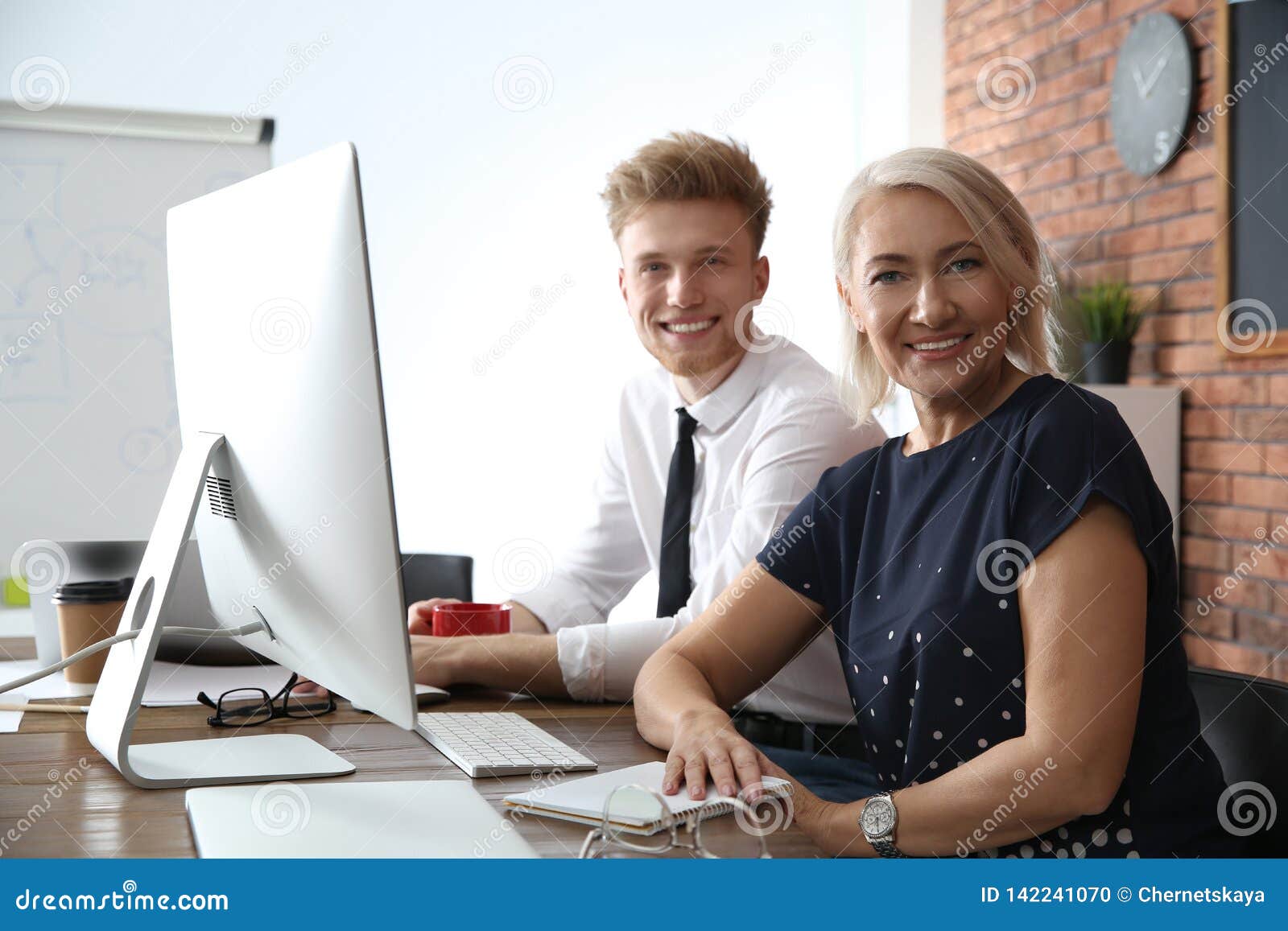Business People Working on Computer at Table in Office Stock Photo ...