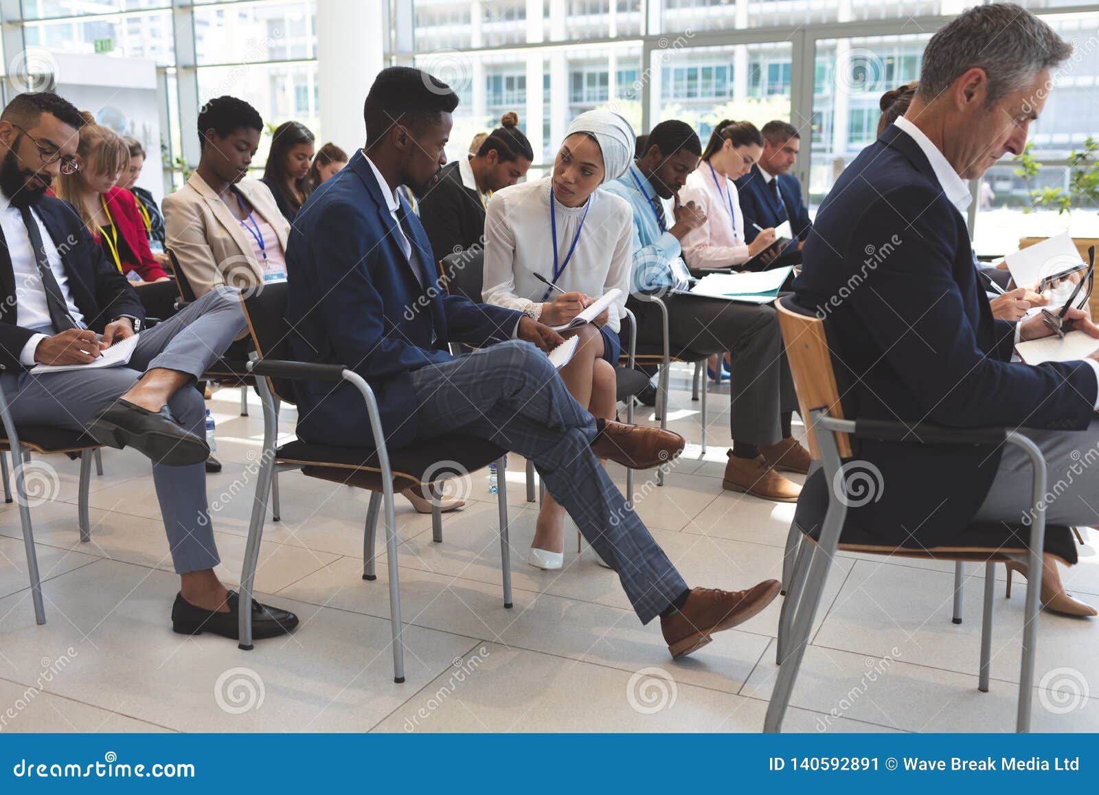 Business People Writing on Notepad during Seminar Stock Image - Image ...