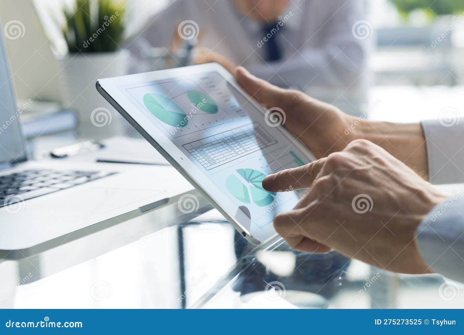 Business Person Analyzing Financial Statistics Displayed on the Tablet ... Business Person Analyzing Financial Statistics Displayed on the Tablet ...