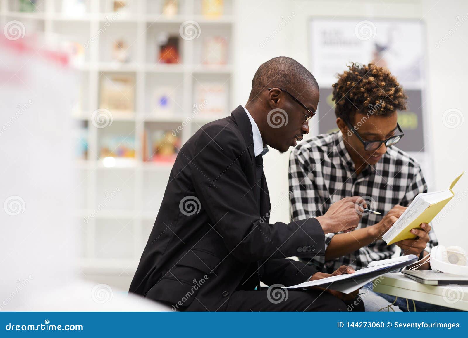 Business School Students Analyzing Notes Stock Photo - Image of young ...