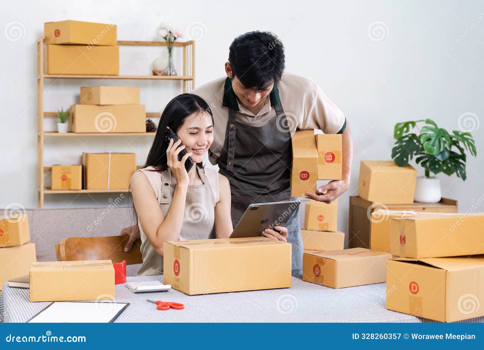 Business Startup Owner Working from Home Packaging Products and Using ...