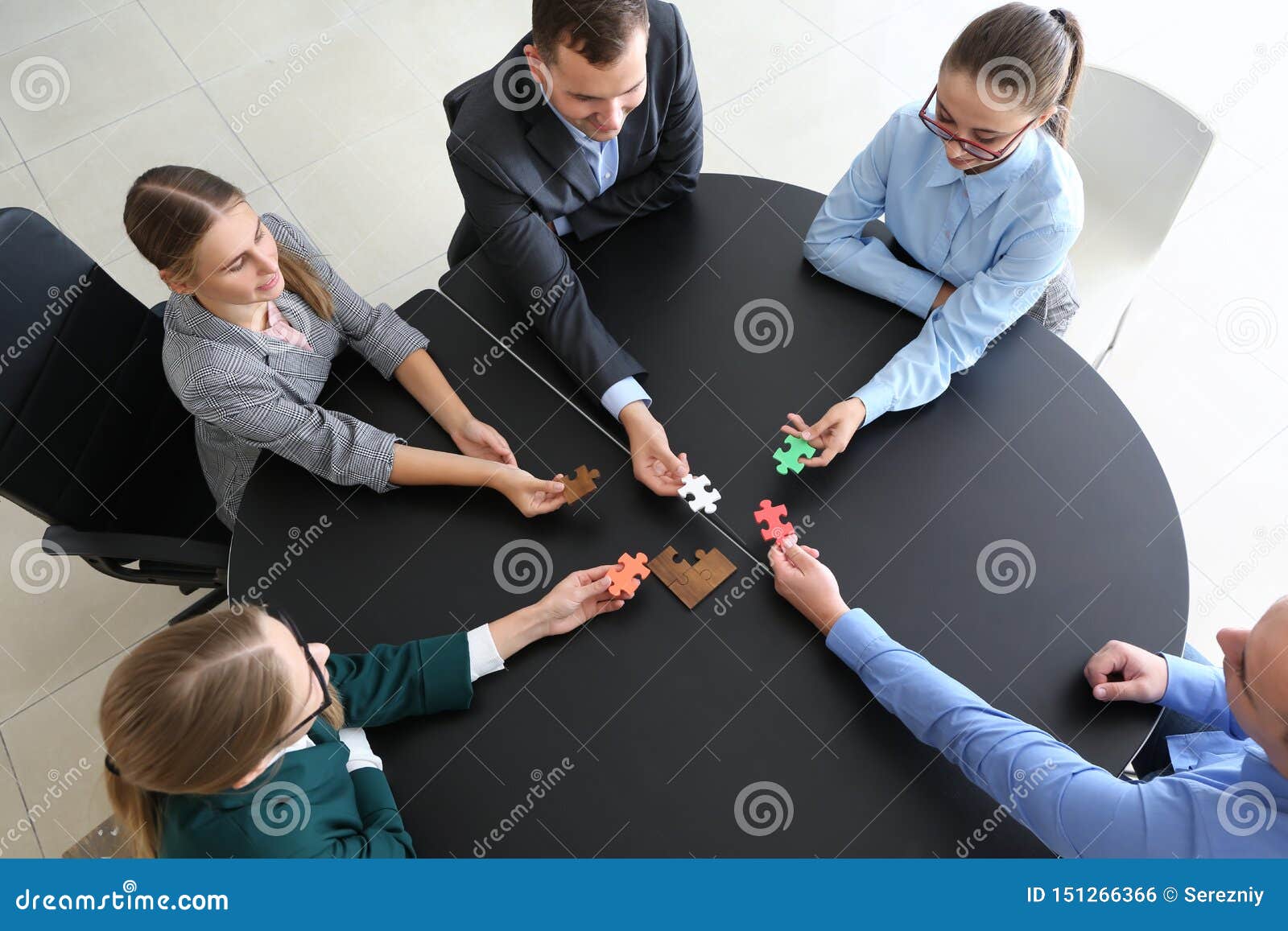 Business Team Assembling Puzzle on Dark Table Stock Photo - Image of ...