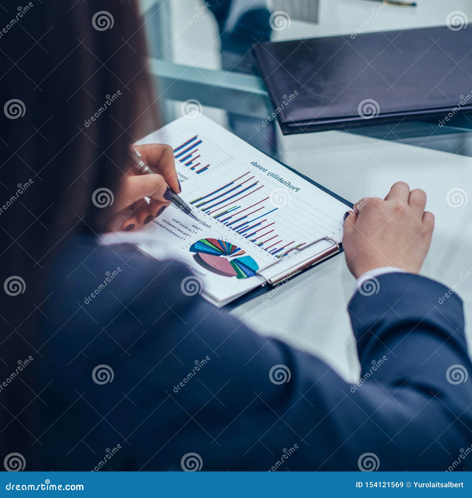 Business Team Discussing Financial Charts on a Workplace Stock Image ... Business Team Discussing Financial Charts on a Workplace Stock Image ...