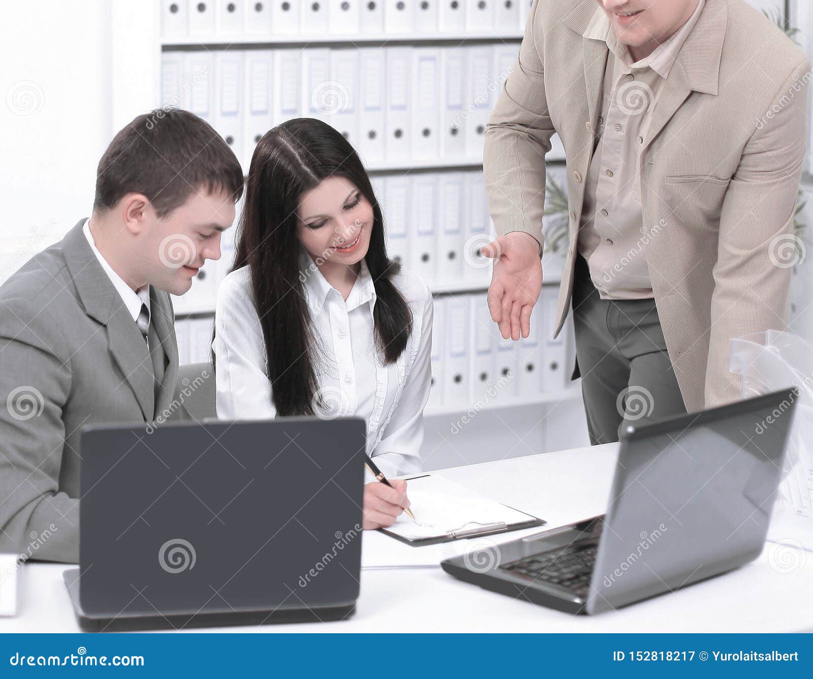 Business Team Discussing Business Issues,sitting Behind a Desk Stock ...