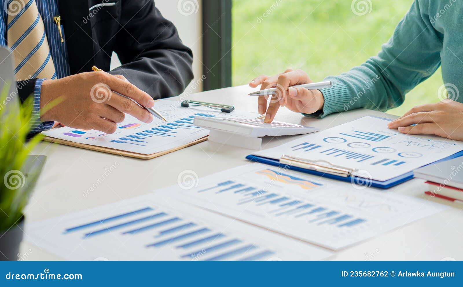 Business Team Discussing and Planning Projects Using Charts, Holding ...