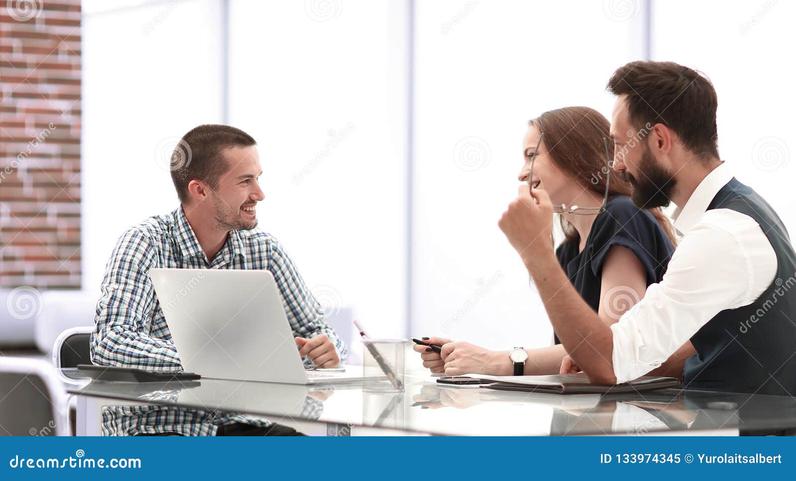 Business Team Discussing Something Sitting at the Office Table Stock ... Business Team Discussing Something Sitting at the Office Table Stock ...