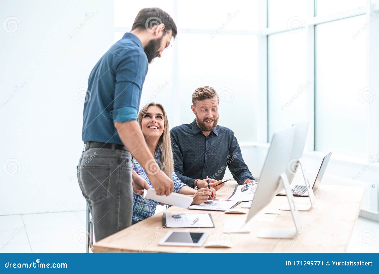 Business Team Discussing Working Documents in a Light Office. Stock ...