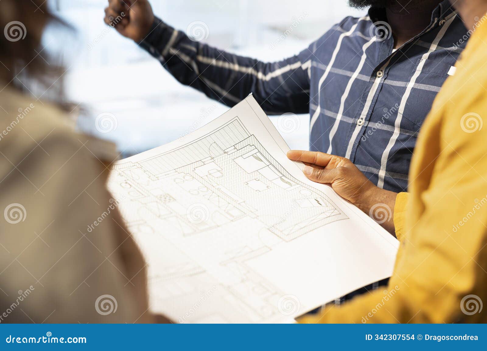 Business Team Evaluating Architectural Blueprints Layout for High Class ...