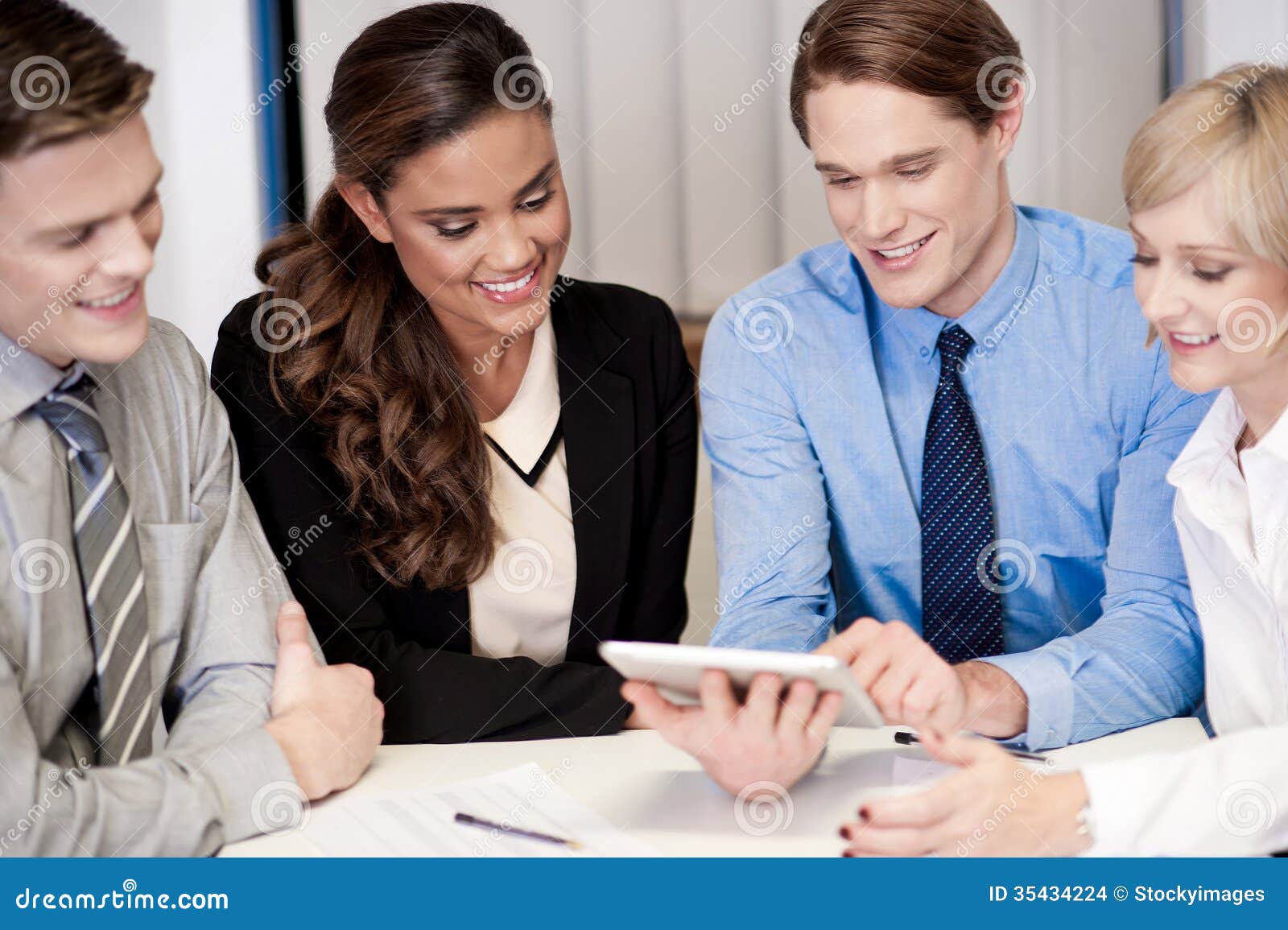 Business Team of Four Enjoying Work Stock Photo - Image of ...