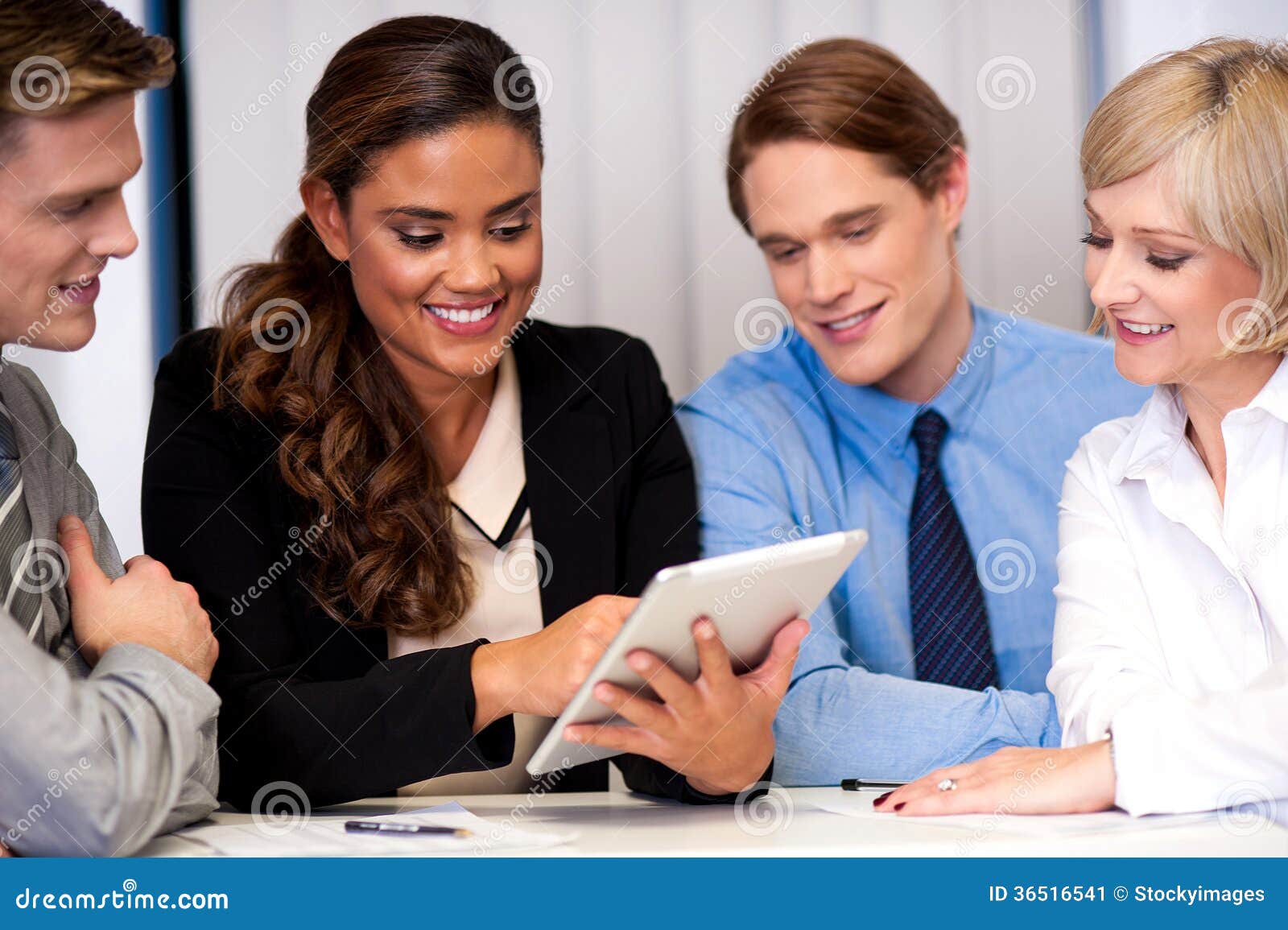 Business Team of Four Enjoying Work Stock Image - Image of contemporary ...