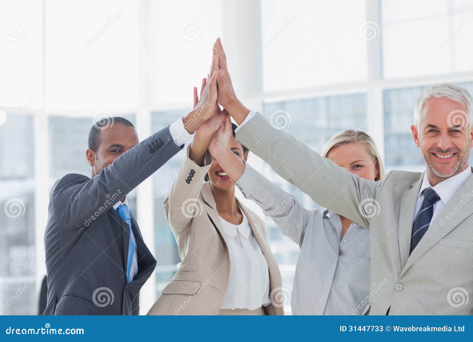 Business Team High Fiving and Smiling at Camera Stock Image - Image of ...
