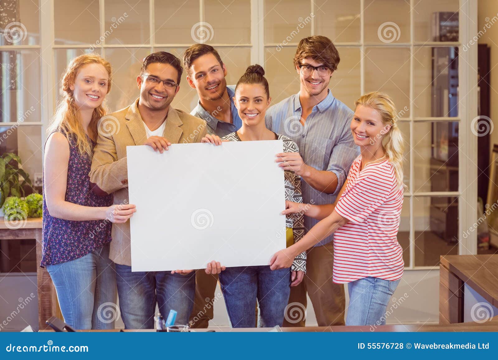 Business Team Holding a White Cardboard Stock Photo - Image of indoors ...
