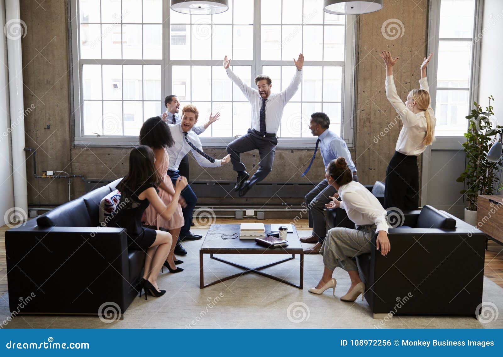 Business Team Jump for Joy at Hitting Target in Meeting Stock Photo ...