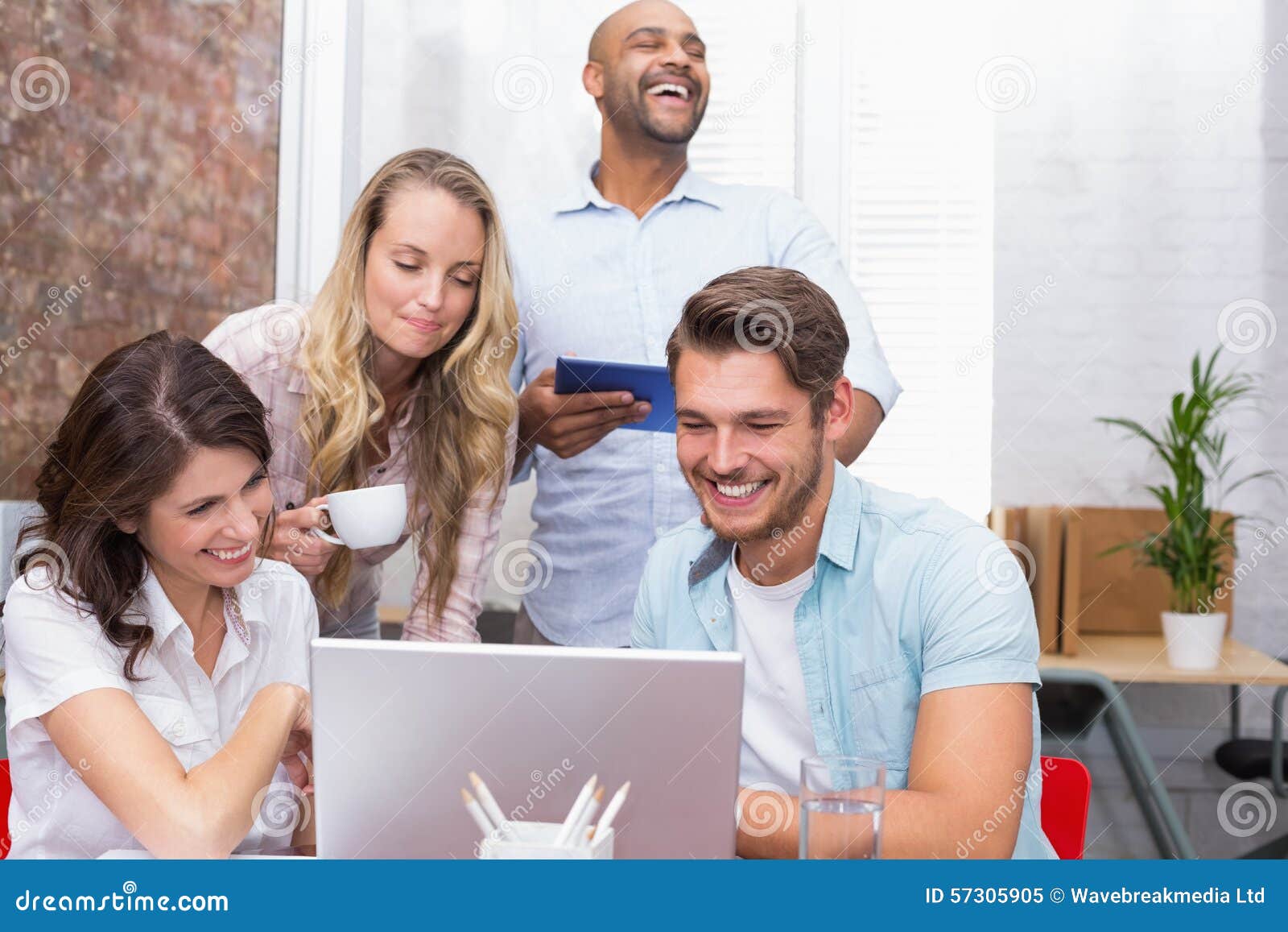 Business Team Laughing Together in Front of the Laptop Stock Image ...