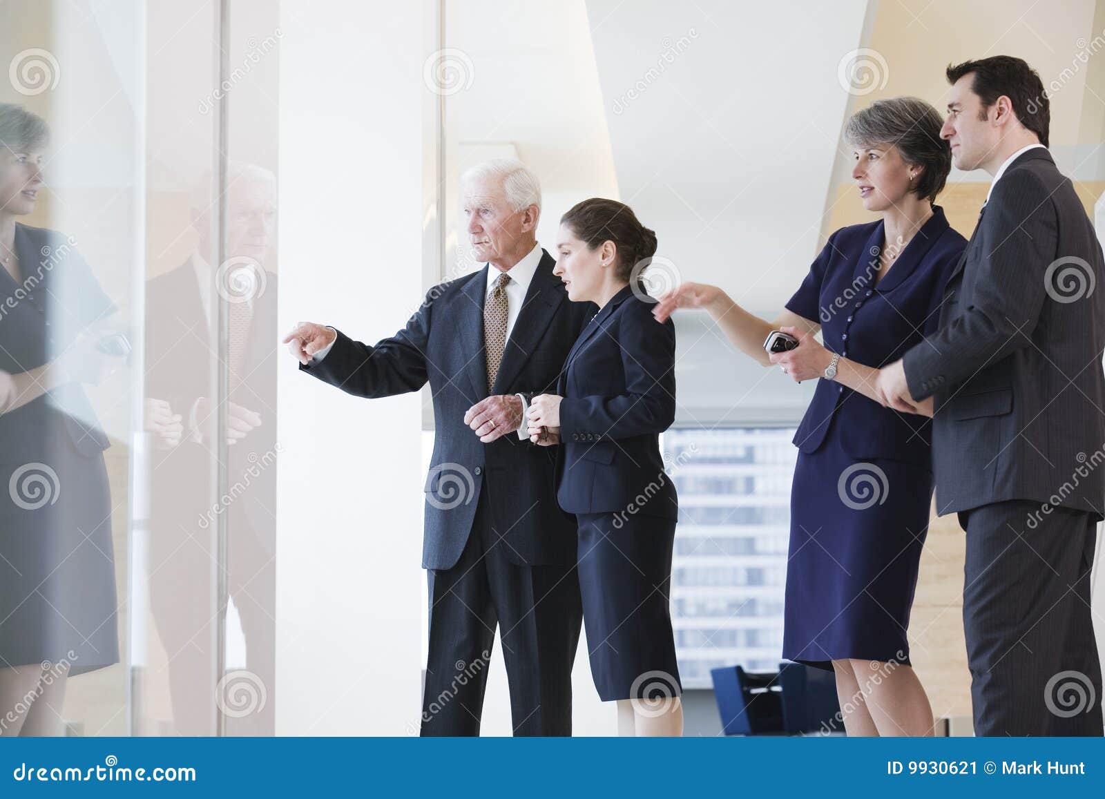Business Team in Lobby Looking Out Window. Stock Image - Image of ...