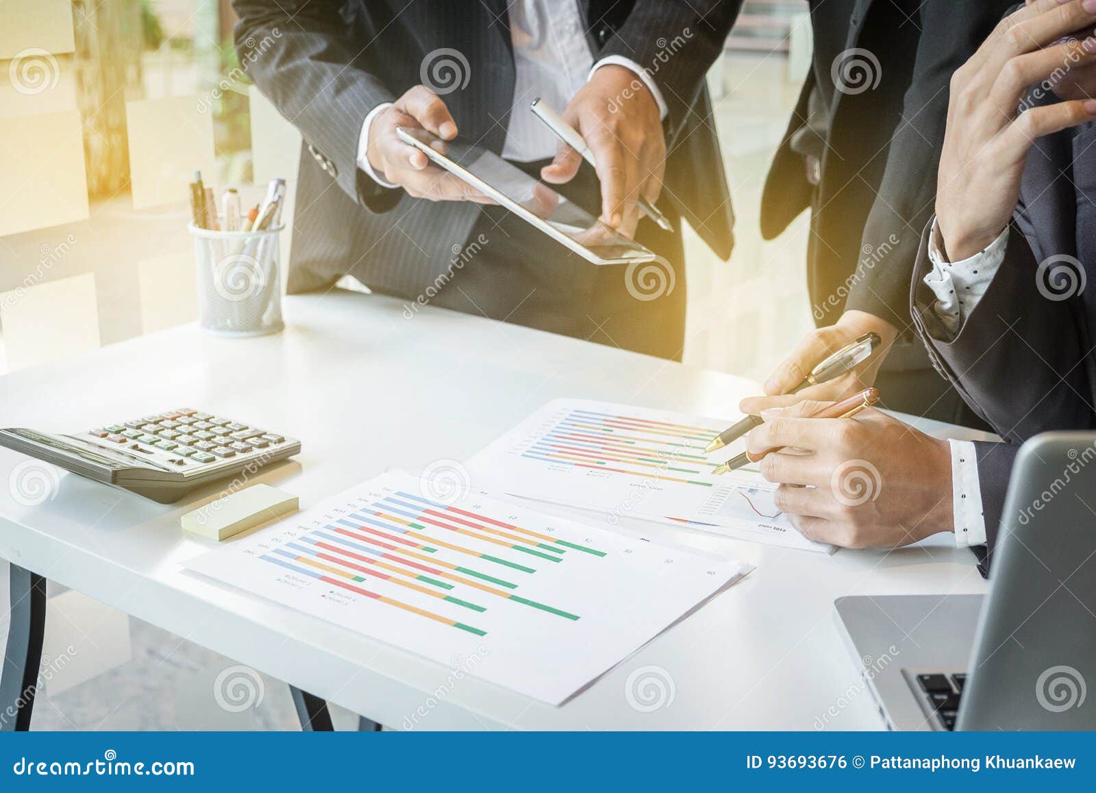 Business Team Looking at Report and Having a Discussion in Office ...