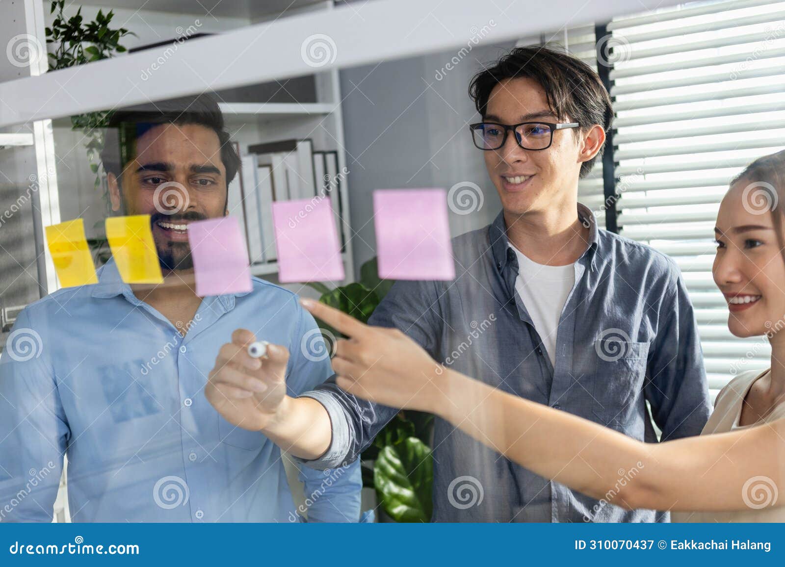 Business Team Meeting Planning New Strategy Using Colored Sticky Notes ...