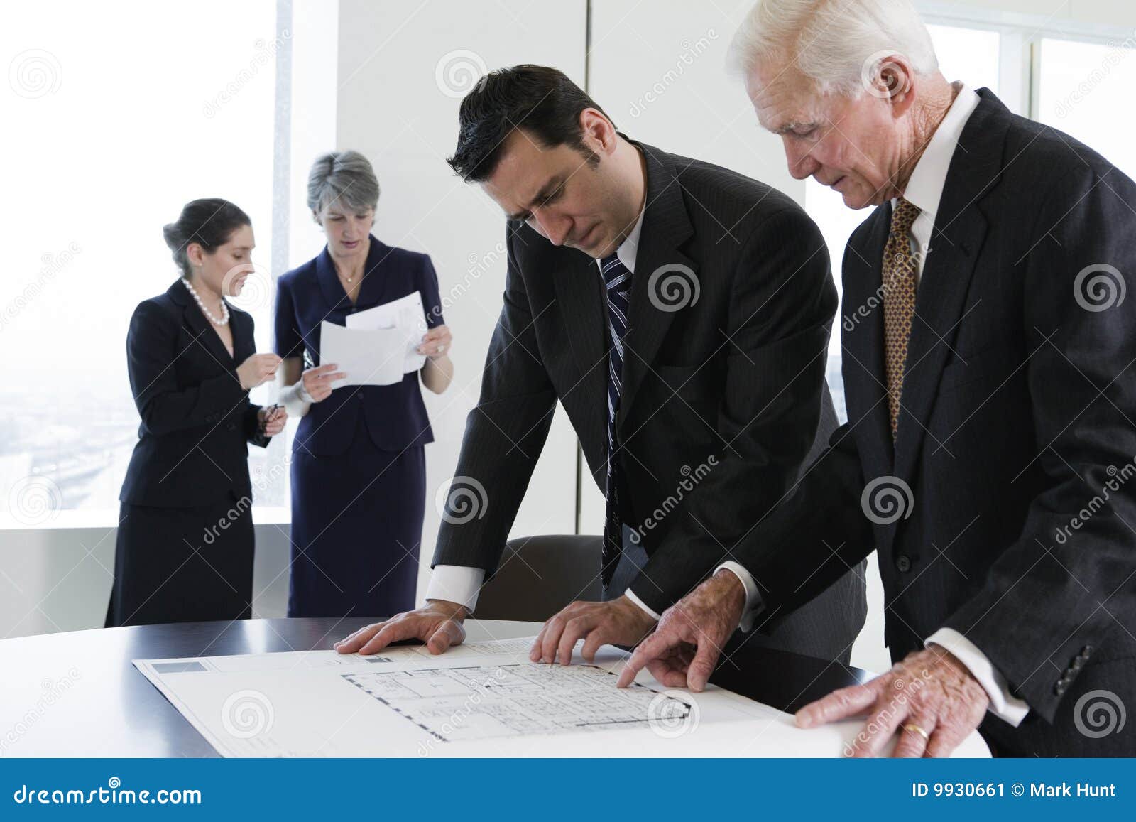 Business Team Reviewing Plans during Meeting. Stock Image - Image of ...