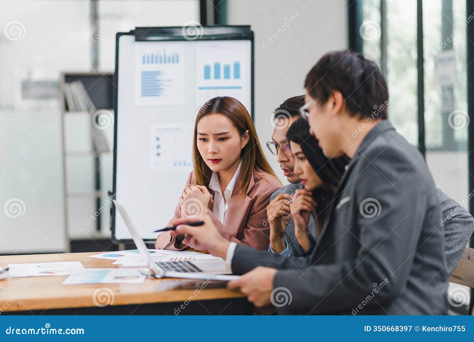 Business Team Serious Discussion, Analyzing Data on Laptop and ...