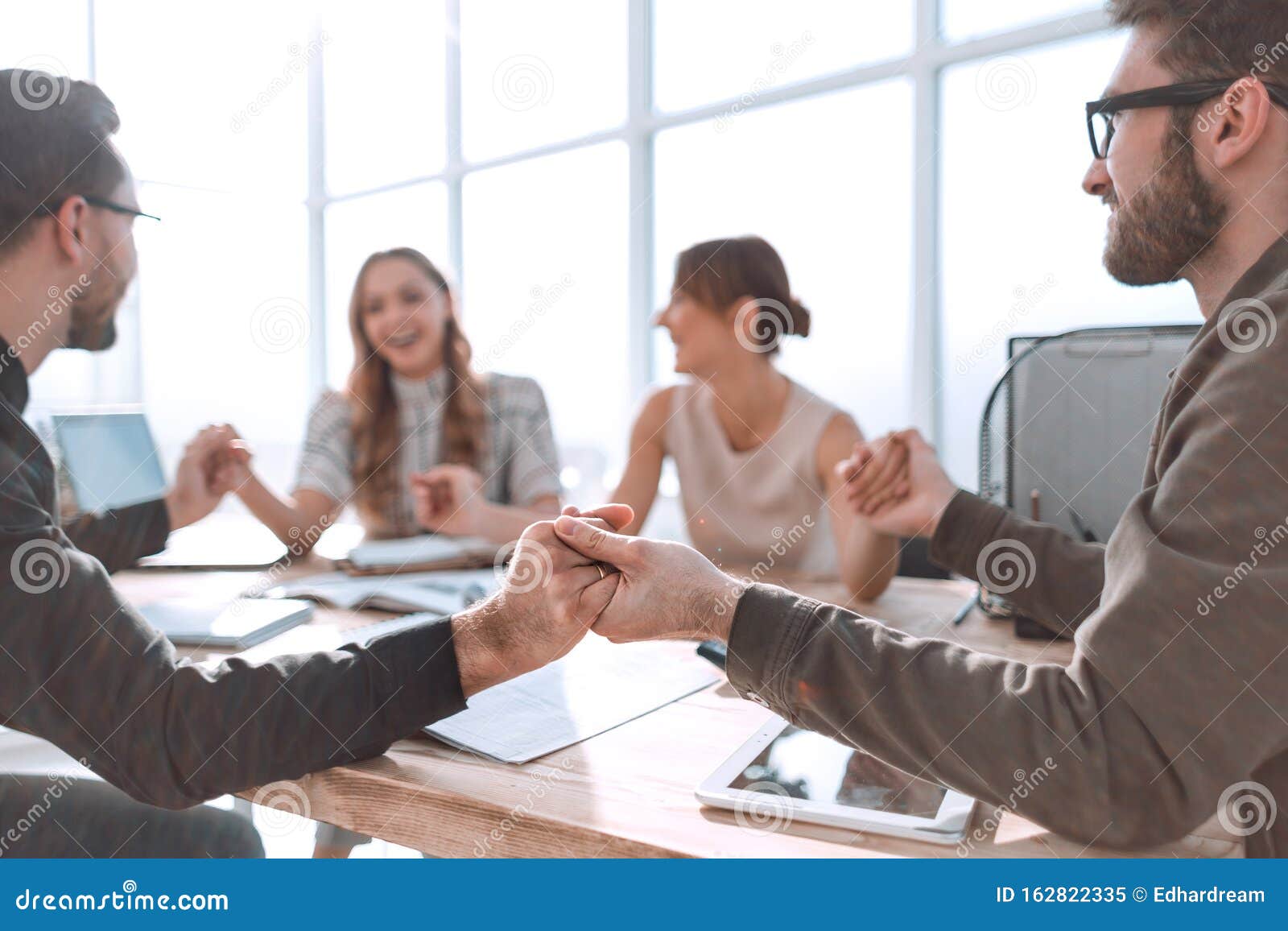 Business Team Sitting at the Table and Showing Their Unity Stock Image ...