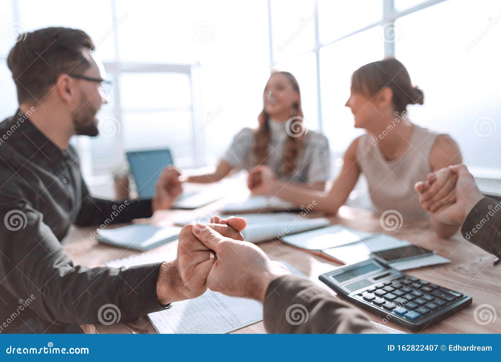 Business Team Sitting at the Table and Showing Their Unity Stock Image ...