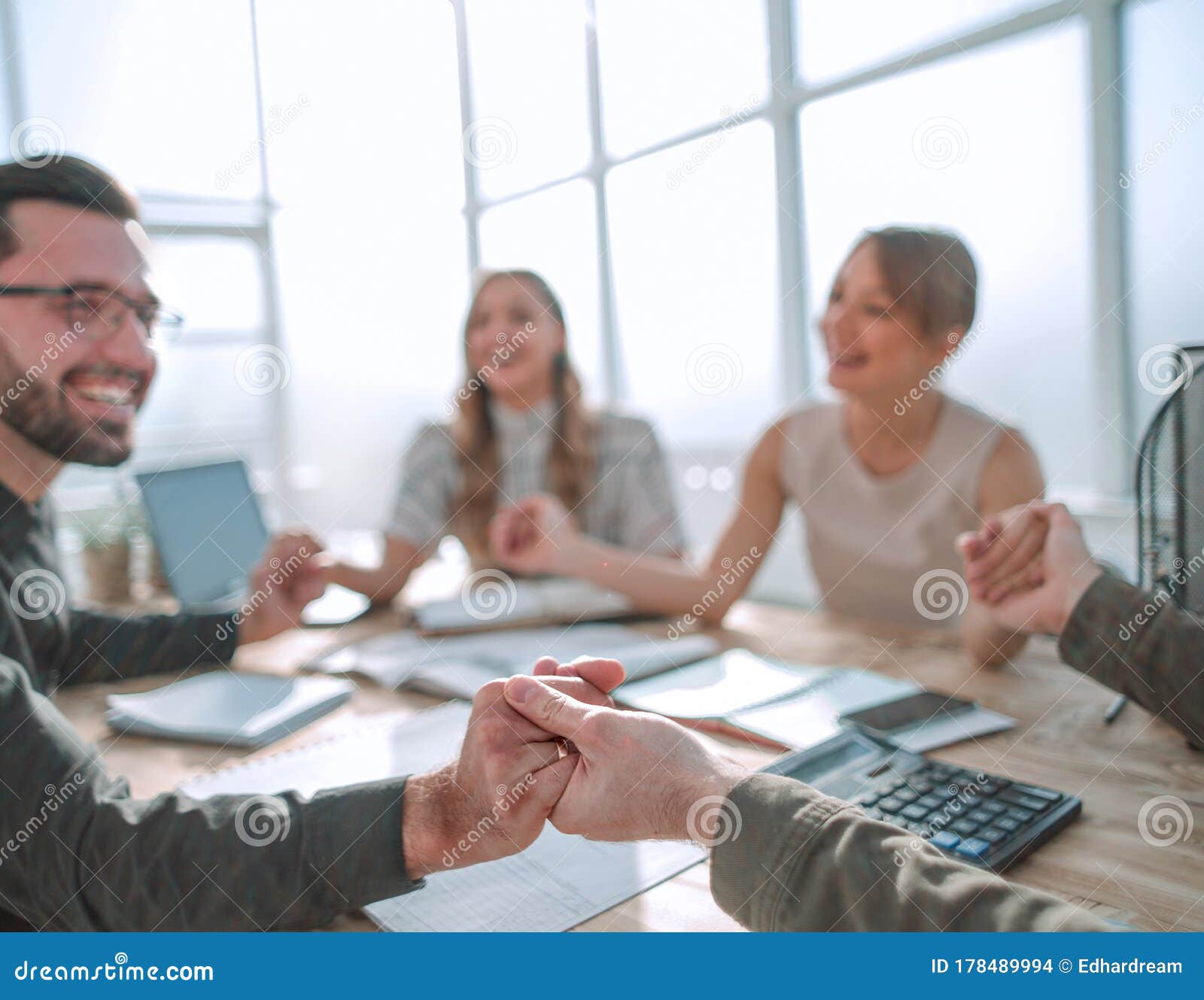 Business Team Sitting at the Table and Showing Their Unity Stock Photo ...