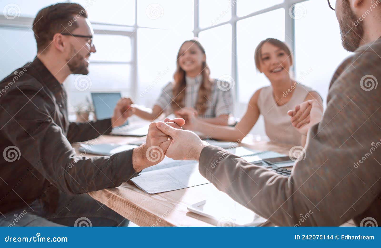 Business Team Sitting at the Table and Showing Their Unity Stock Photo ...