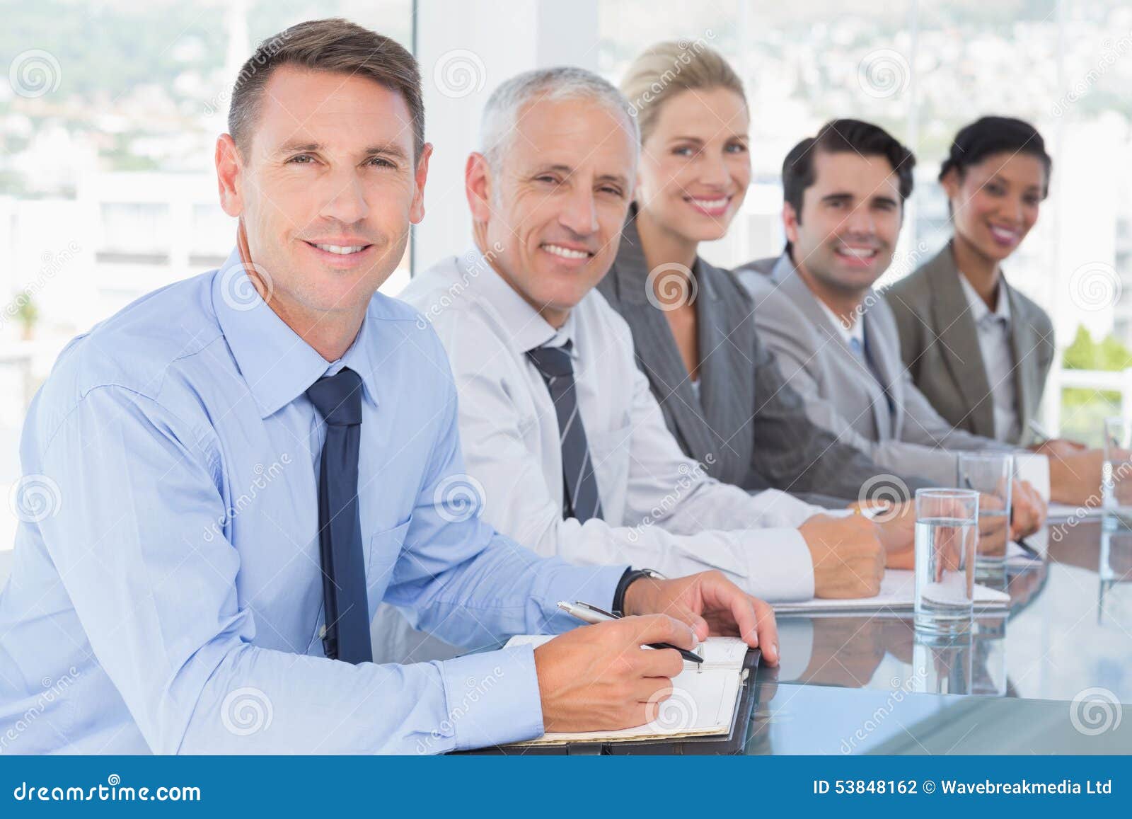 Business Team Smiling at Camera during Conference Stock Photo - Image ...