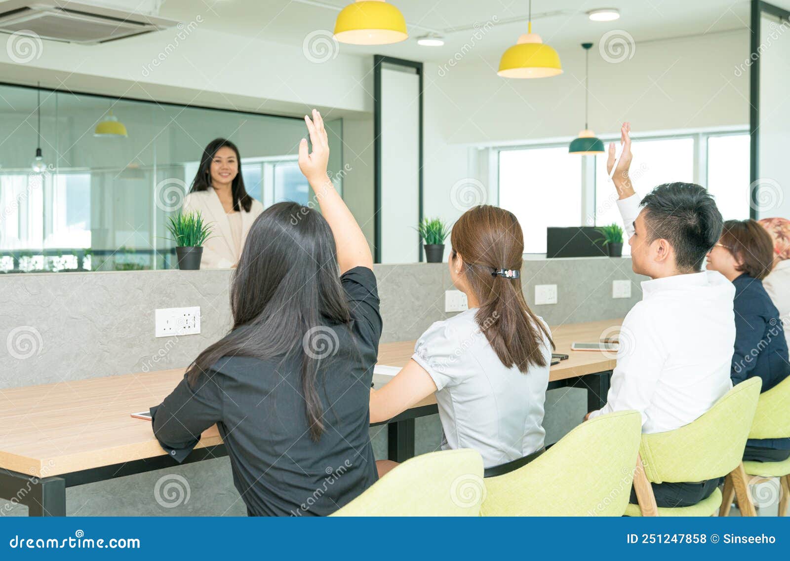 Business Team Training in Progress with Trainees Raising Hands To Ask ...
