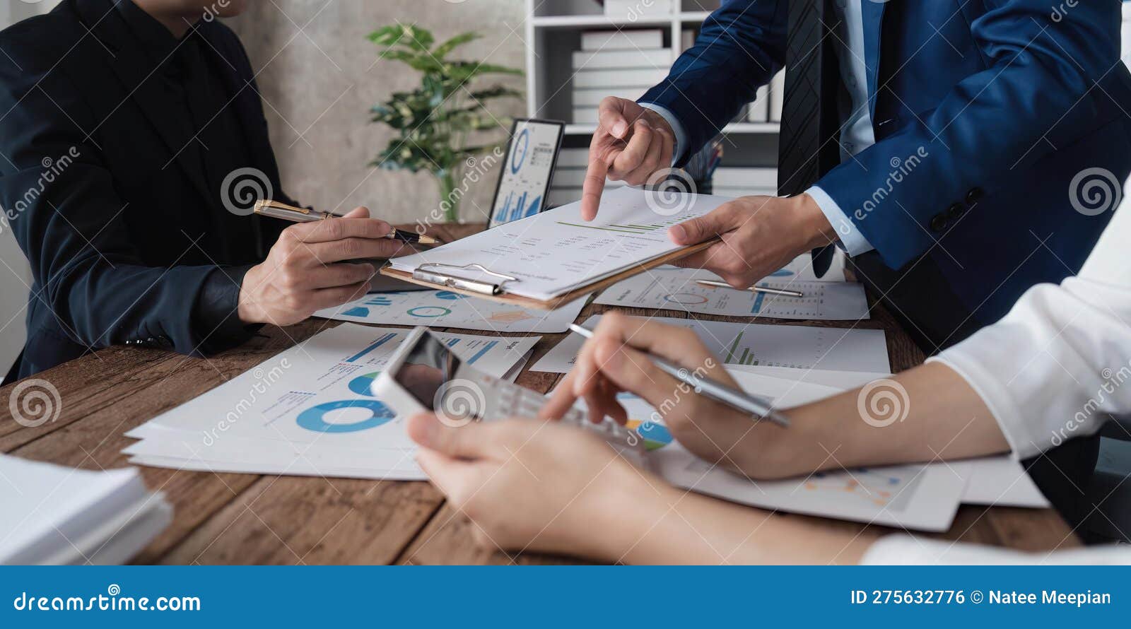 Business Team Using a Calculator To Calculate the Numbers of Statistic ...