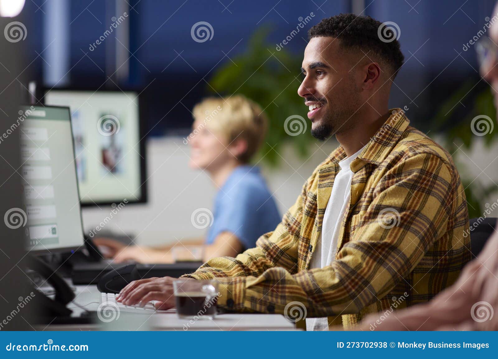 Business Team Using Computers at Desks in Office Working Late Stock ...