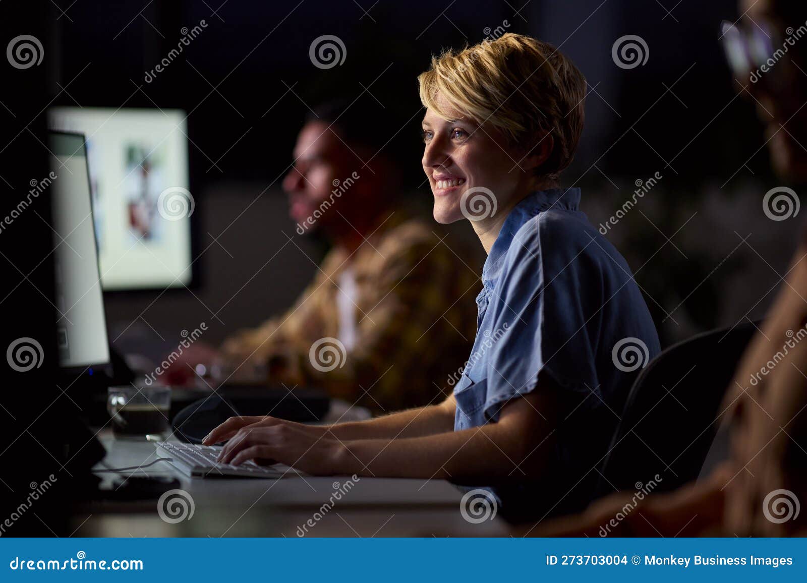 Business Team Using Computers at Desks in Office Working Late Stock ...