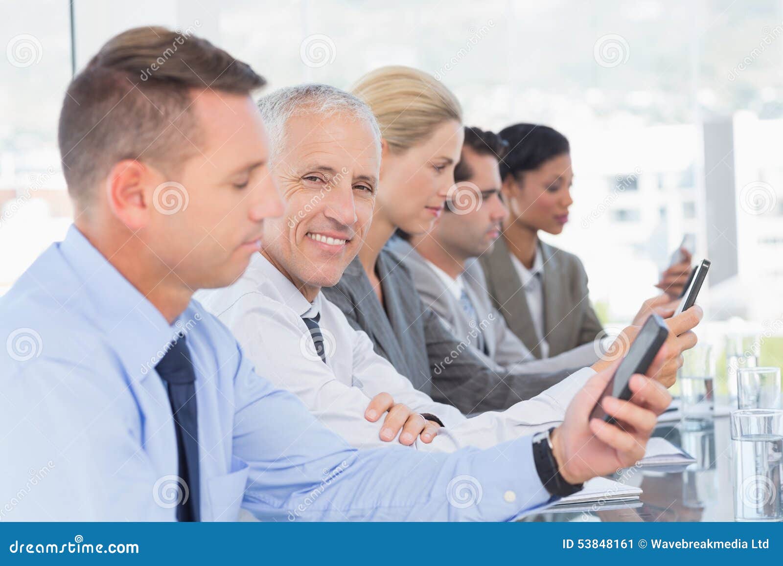 Business Team Using Their Mobile Phone Stock Image - Image of mobile ...
