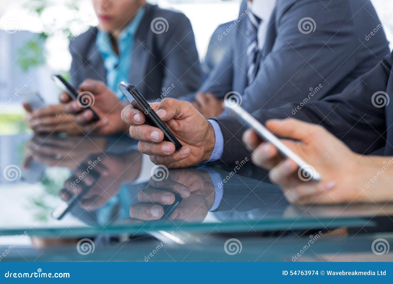 Business Team Using Their Mobile Phone Stock Photo - Image of ...