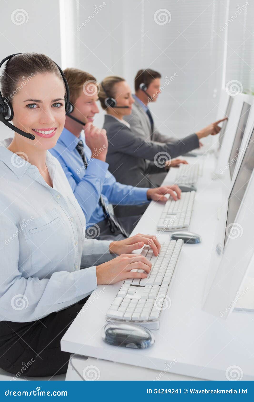 Business Team Working on Computers and Wearing Headsets Stock Image ...