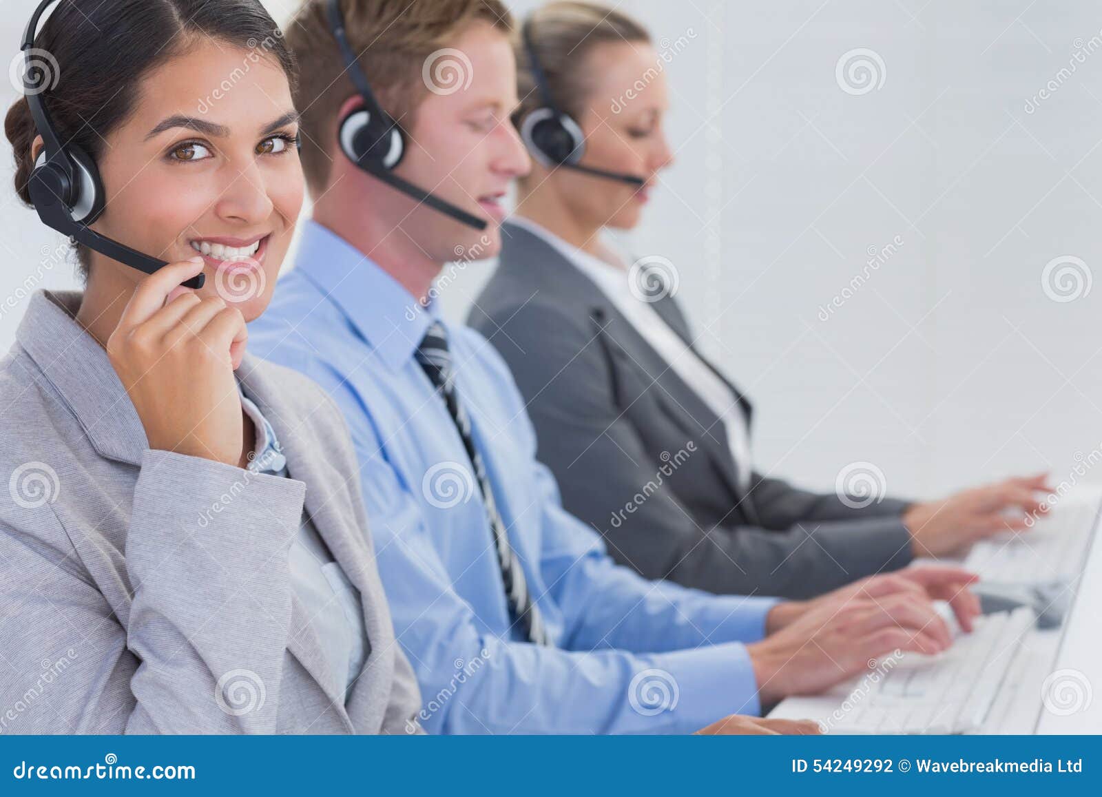 Business Team Working on Computers and Wearing Headsets Stock Photo ...
