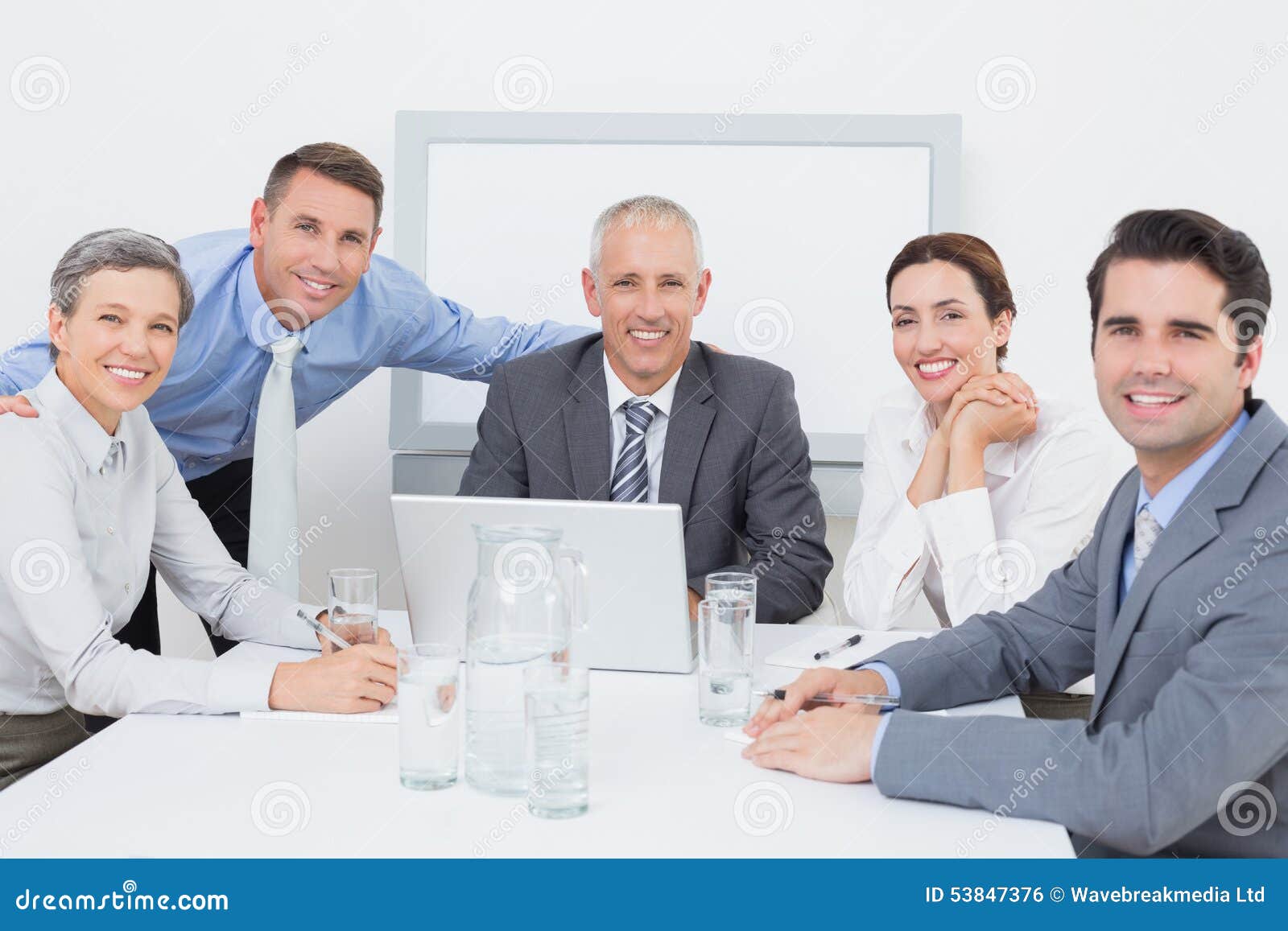 Business Team Working Happily Together on Laptop Stock Photo - Image of ...