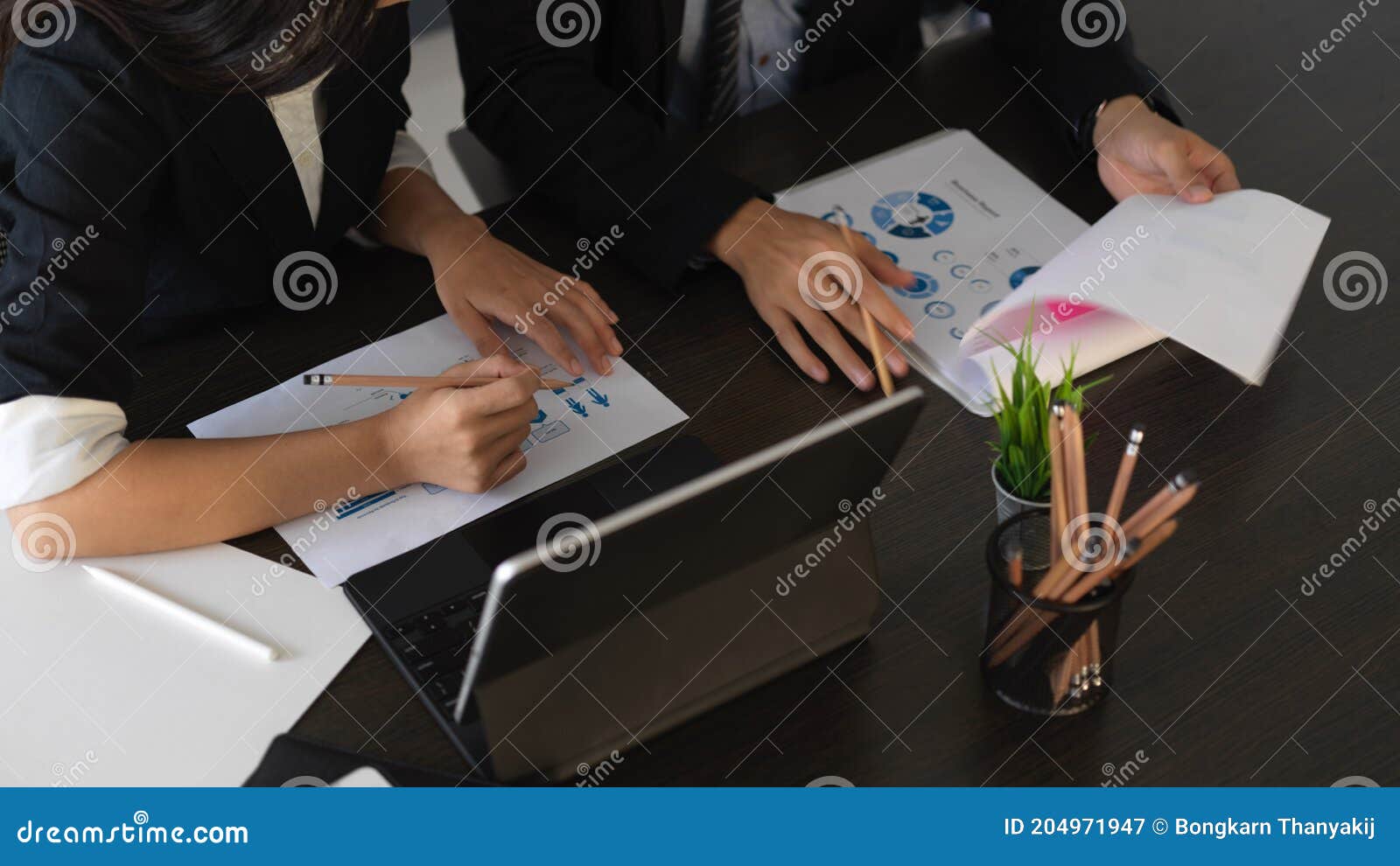Business Team Working Together on Business Documents in Meeting Room ...