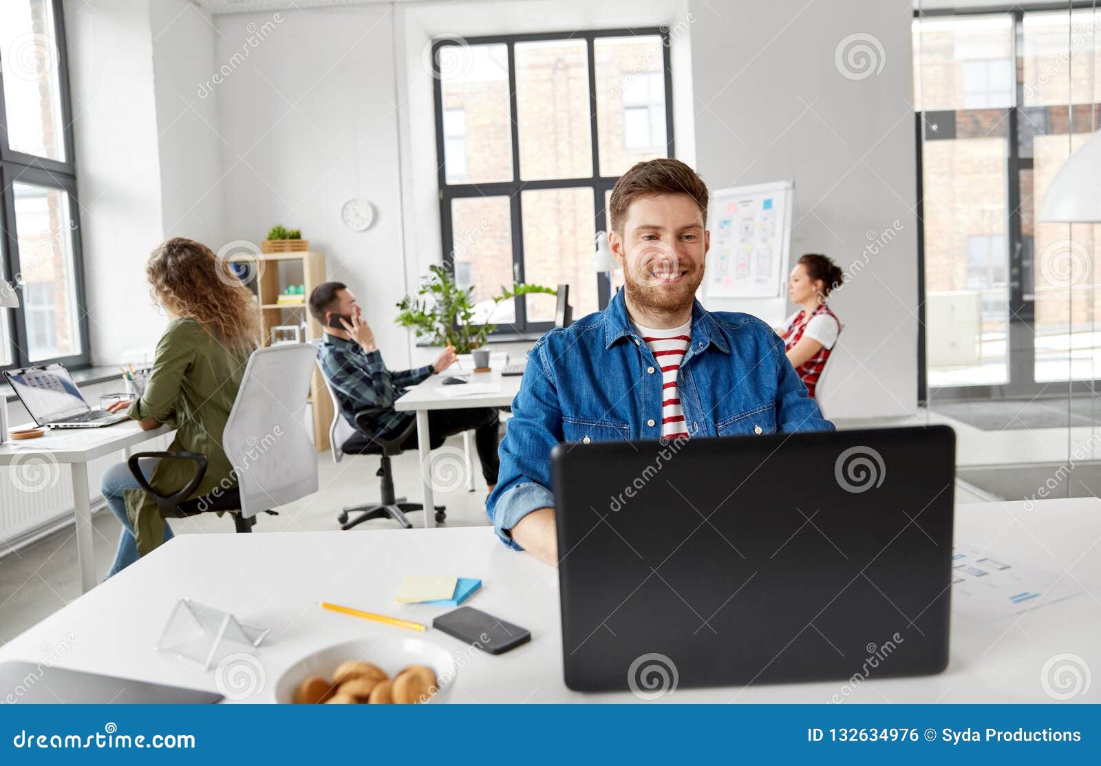 Smiling Creative Man with Laptop Working at Office Stock Photo - Image ...
