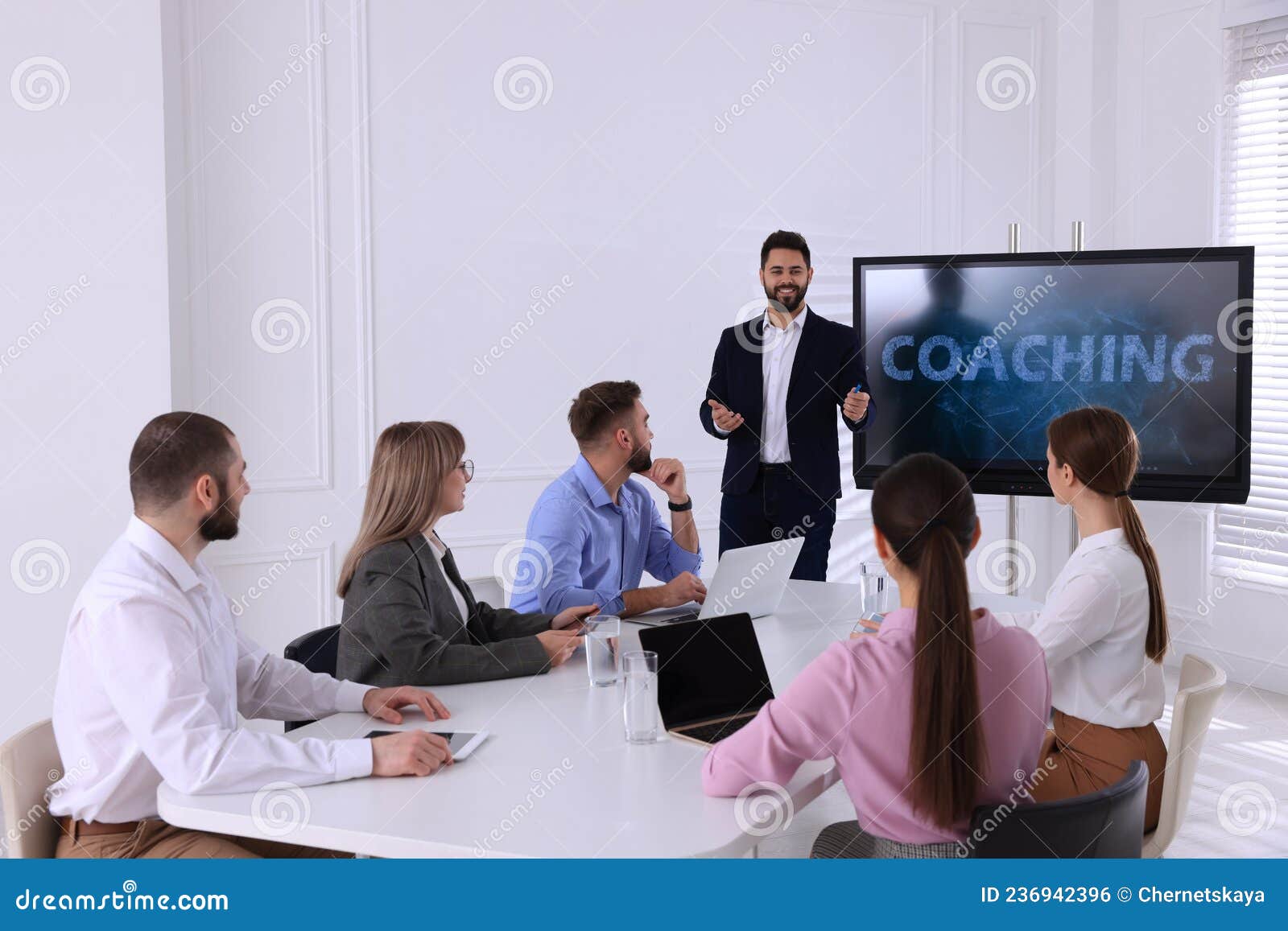 Business Trainer Near Interactive Board in Meeting Room during ...