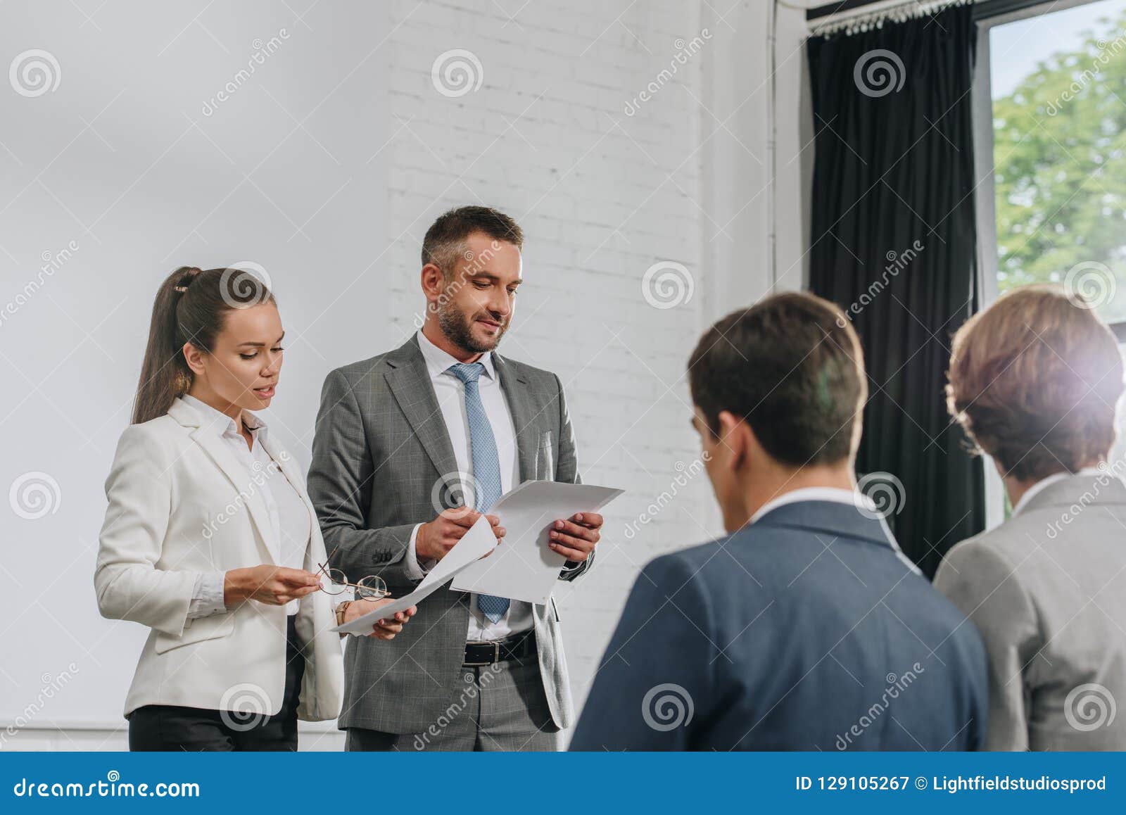 Business Trainers Standing on Stage with Documents Stock Image - Image ...