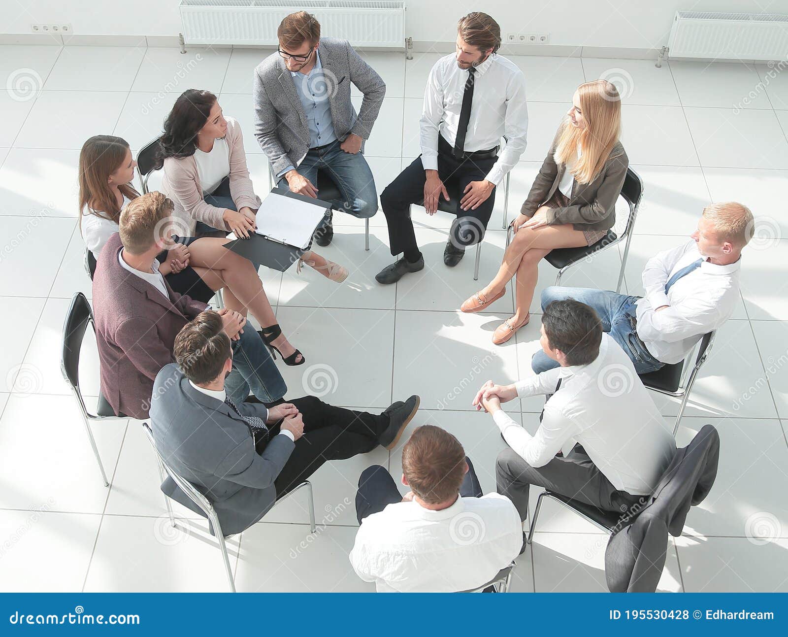 Business Training Participants Sitting in a Circle and Looking at the ...