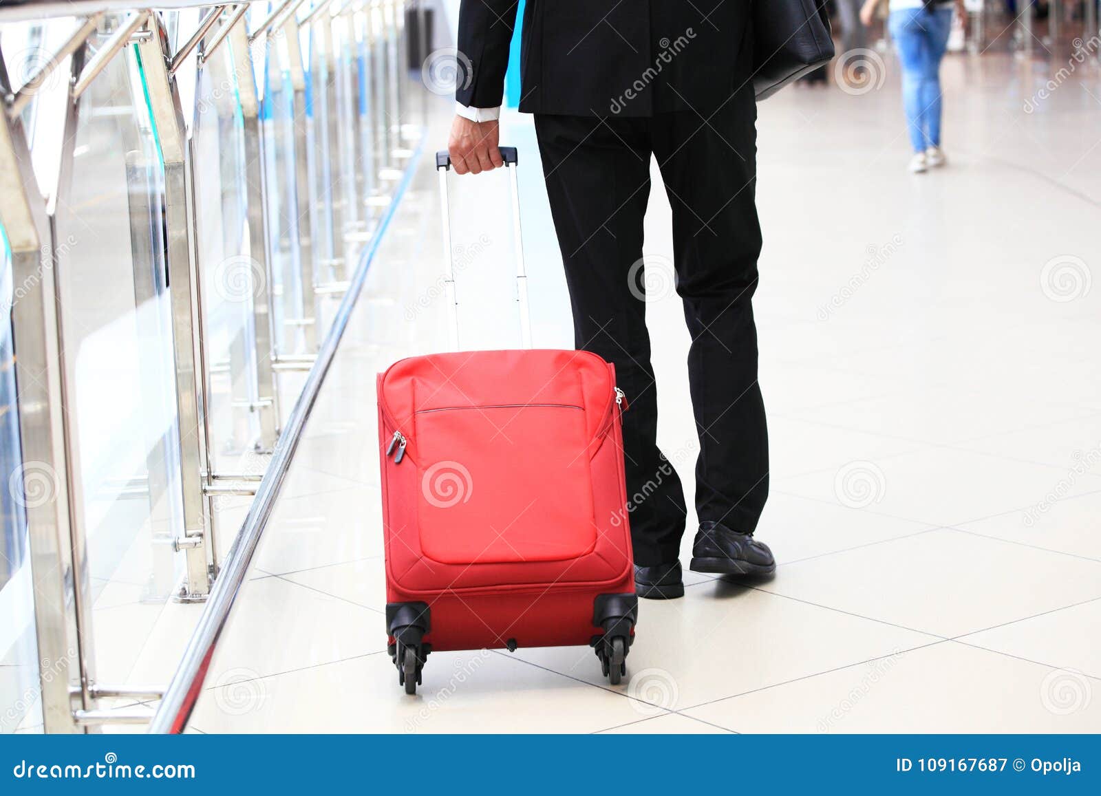 Close-up of Businessman Carrying Suitcase while Walking through a ... Close-up of Businessman Carrying Suitcase while Walking through a ...