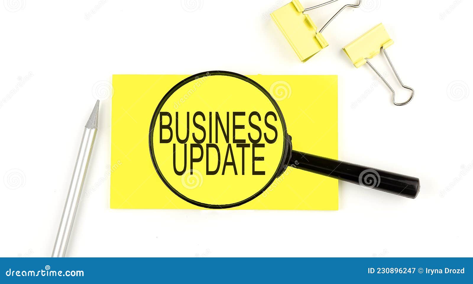 BUSINESS UPDATE Text on the Sticker through Magnifier. View from Above ...